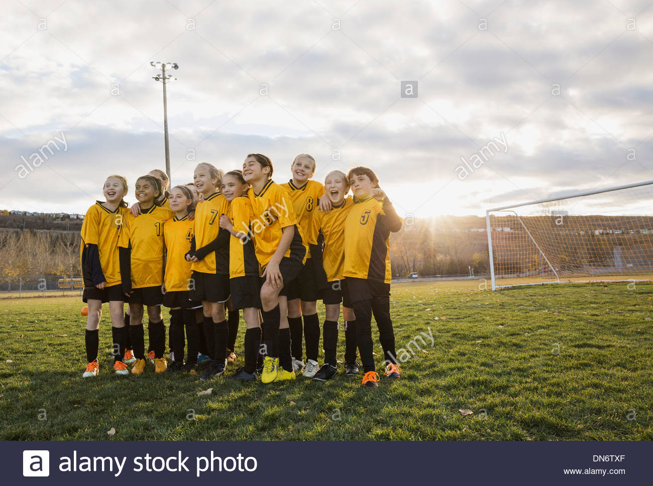 Girls soccer team posing with trophy Stock Photo - Alamy