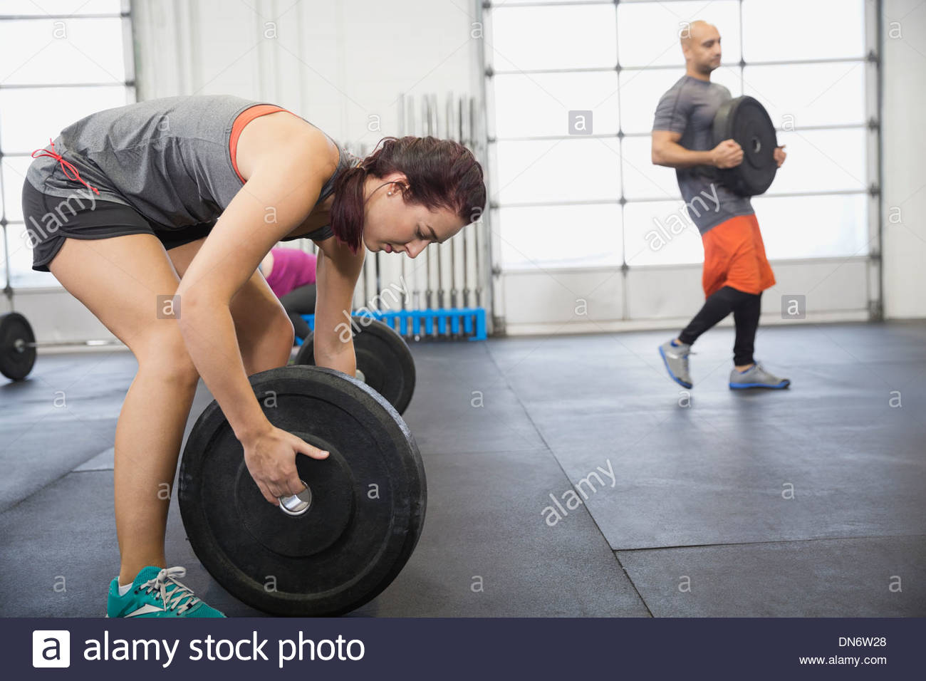 Adding weights hi-res stock photography and images - Alamy