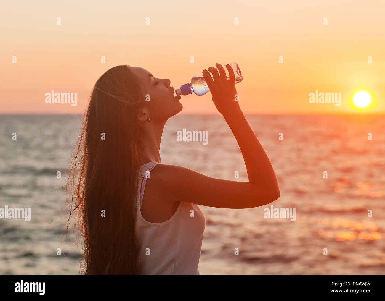 Enjoyment - free happy woman enjoying sunset. Asian Caucasian female ...