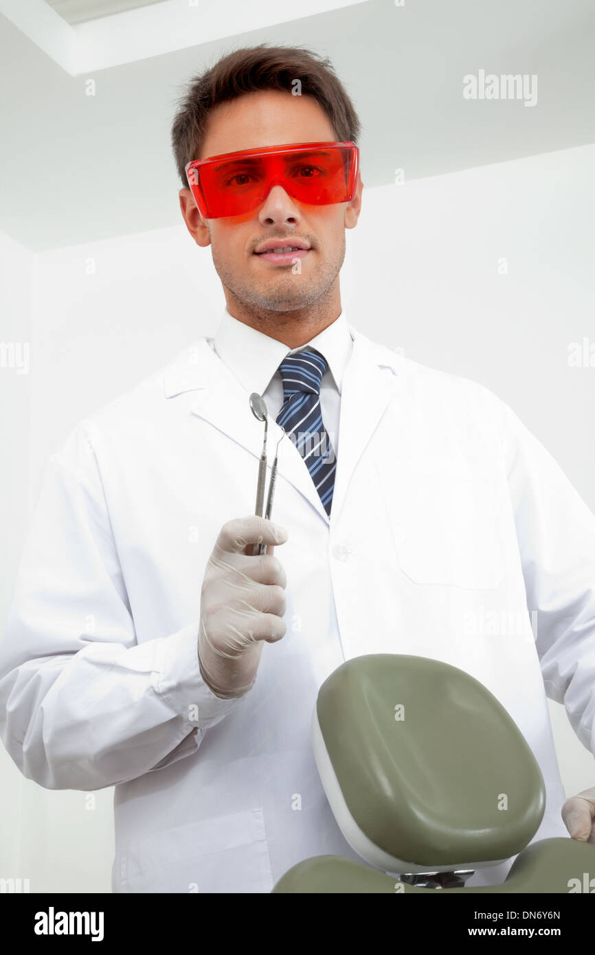 Young Dentist Holding Tools Stock Photo - Alamy