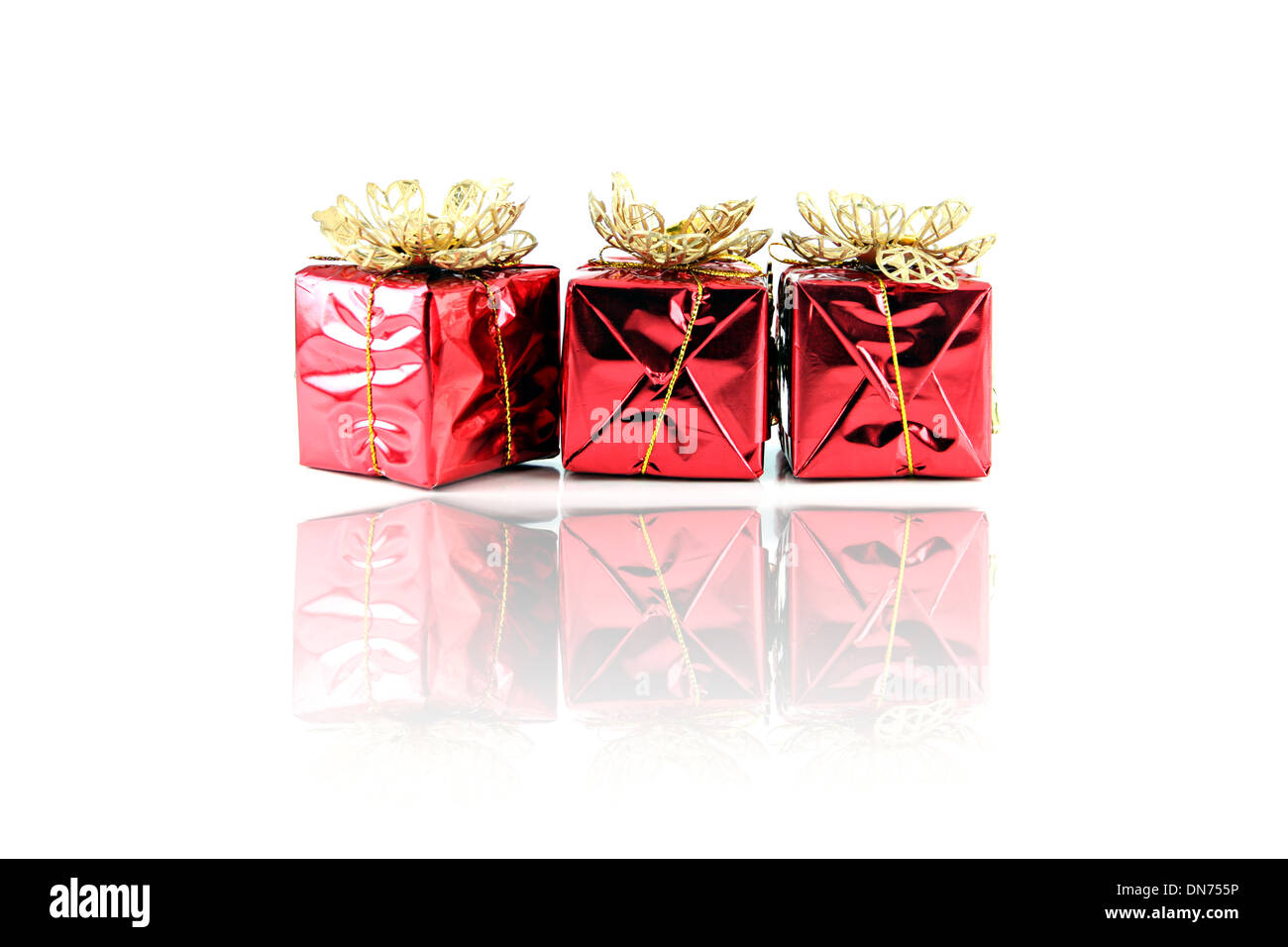 Red gift box with gold thread attached Stock Photo - Alamy