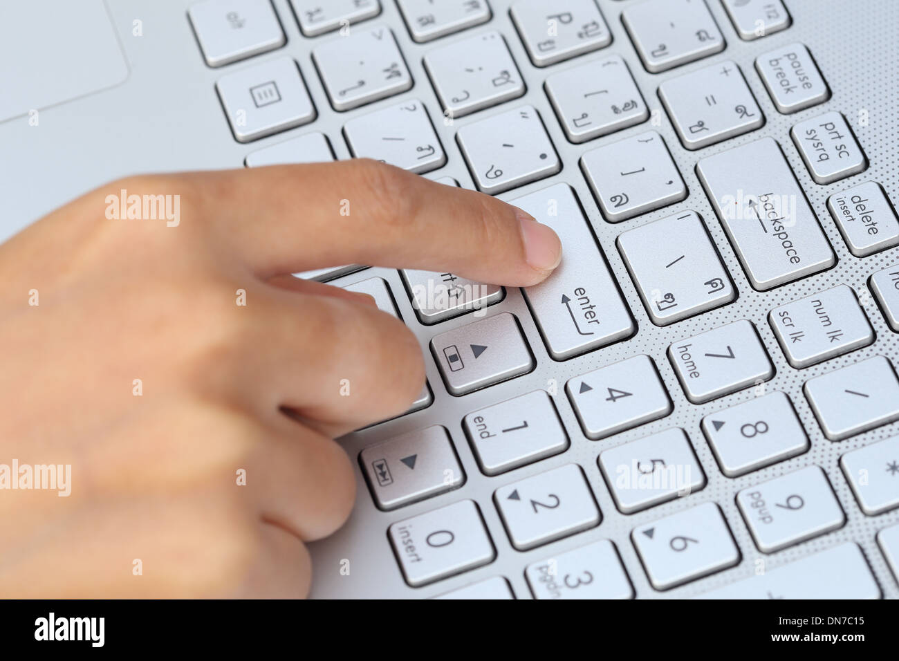 finger pushing the enter button of keyboard Stock Photo - Alamy