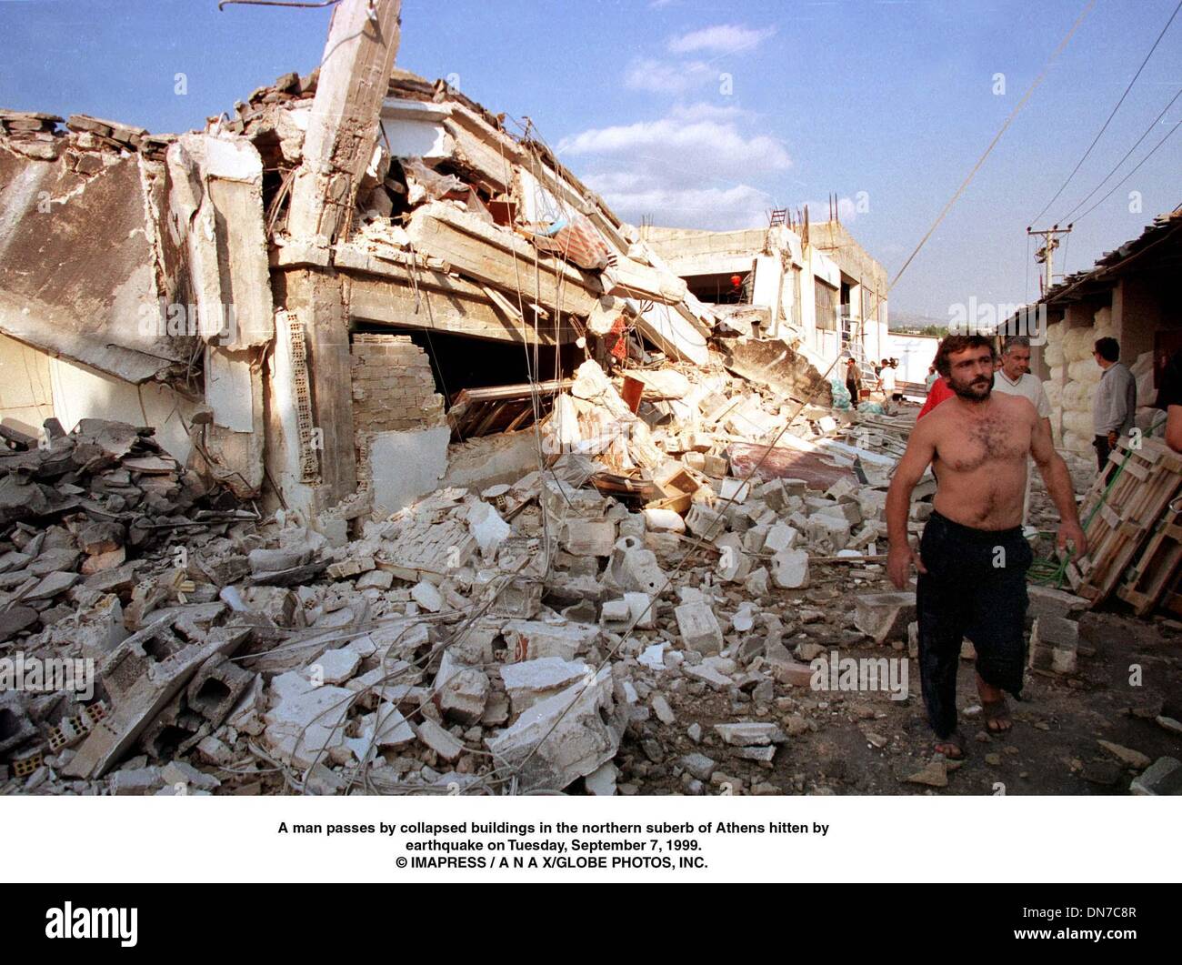 Sept. 8, 1999 - Athens, GRC - A man passes by collapsed buildings in ...