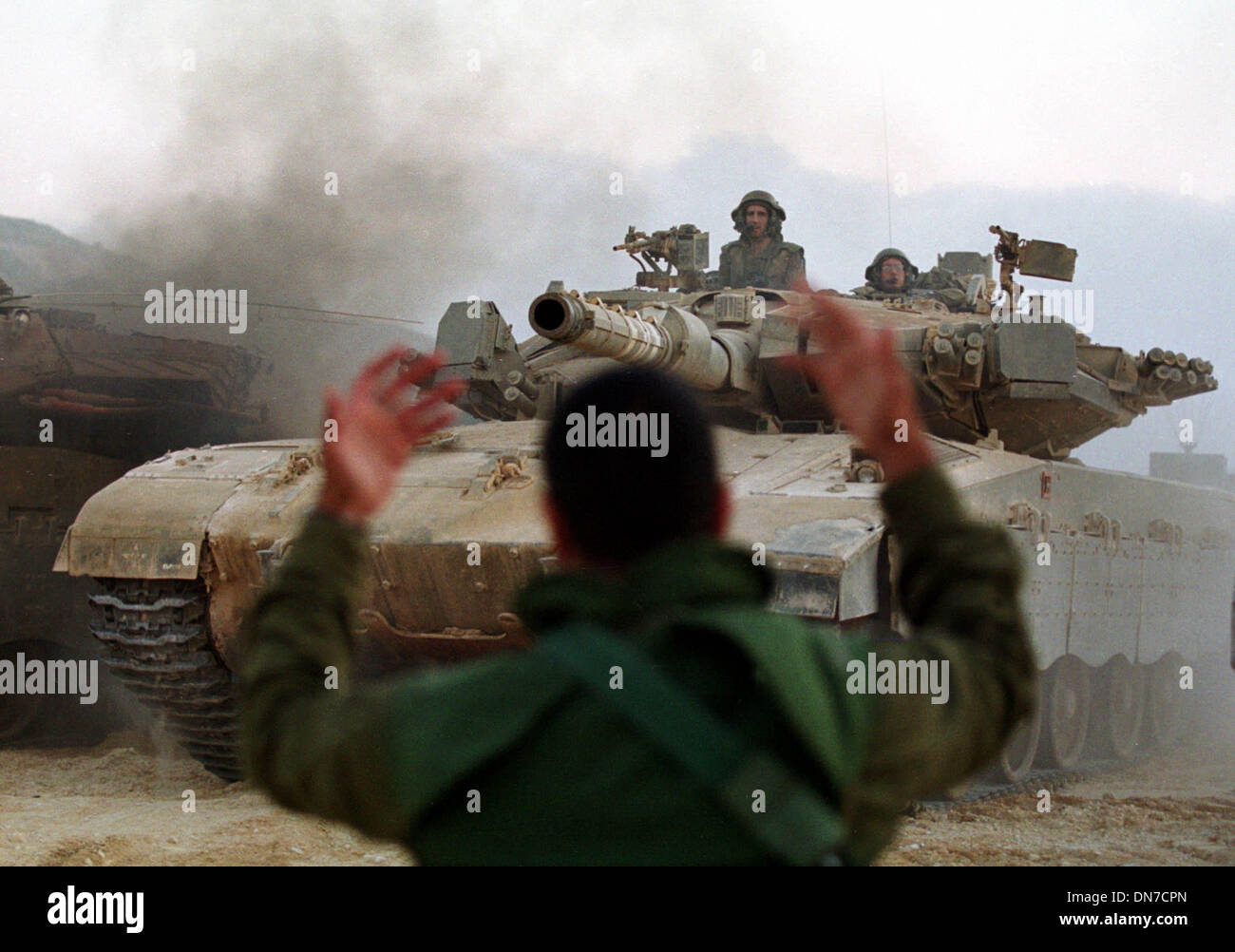 May 24, 2000 - Metulla, ISRAEL - An Israeli soldier guides an Israeli ...