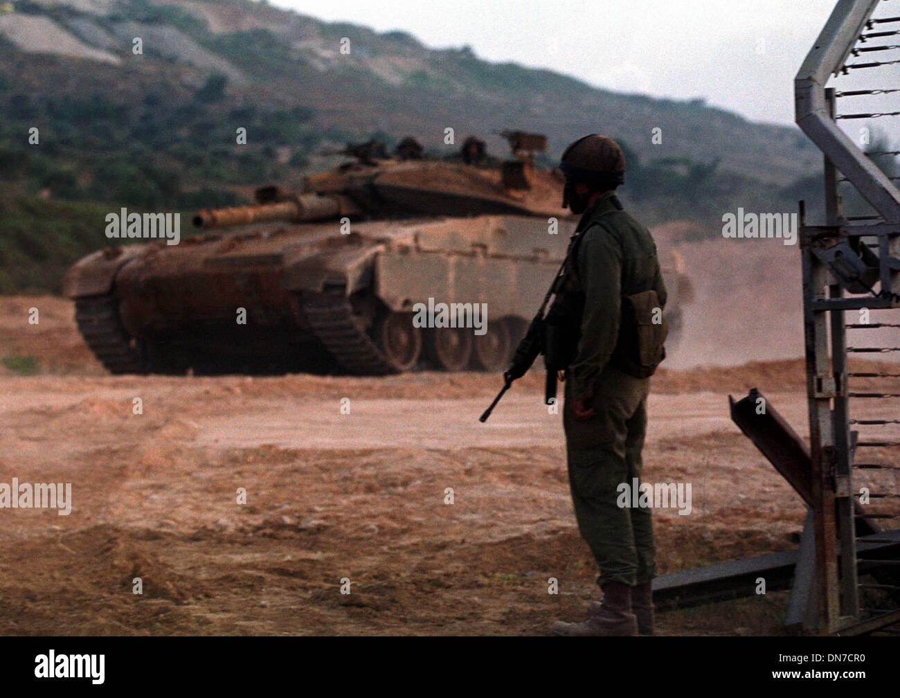 May 24, 2000 - Metulla, ISRAEL - An Israeli soldier watches one of the ...
