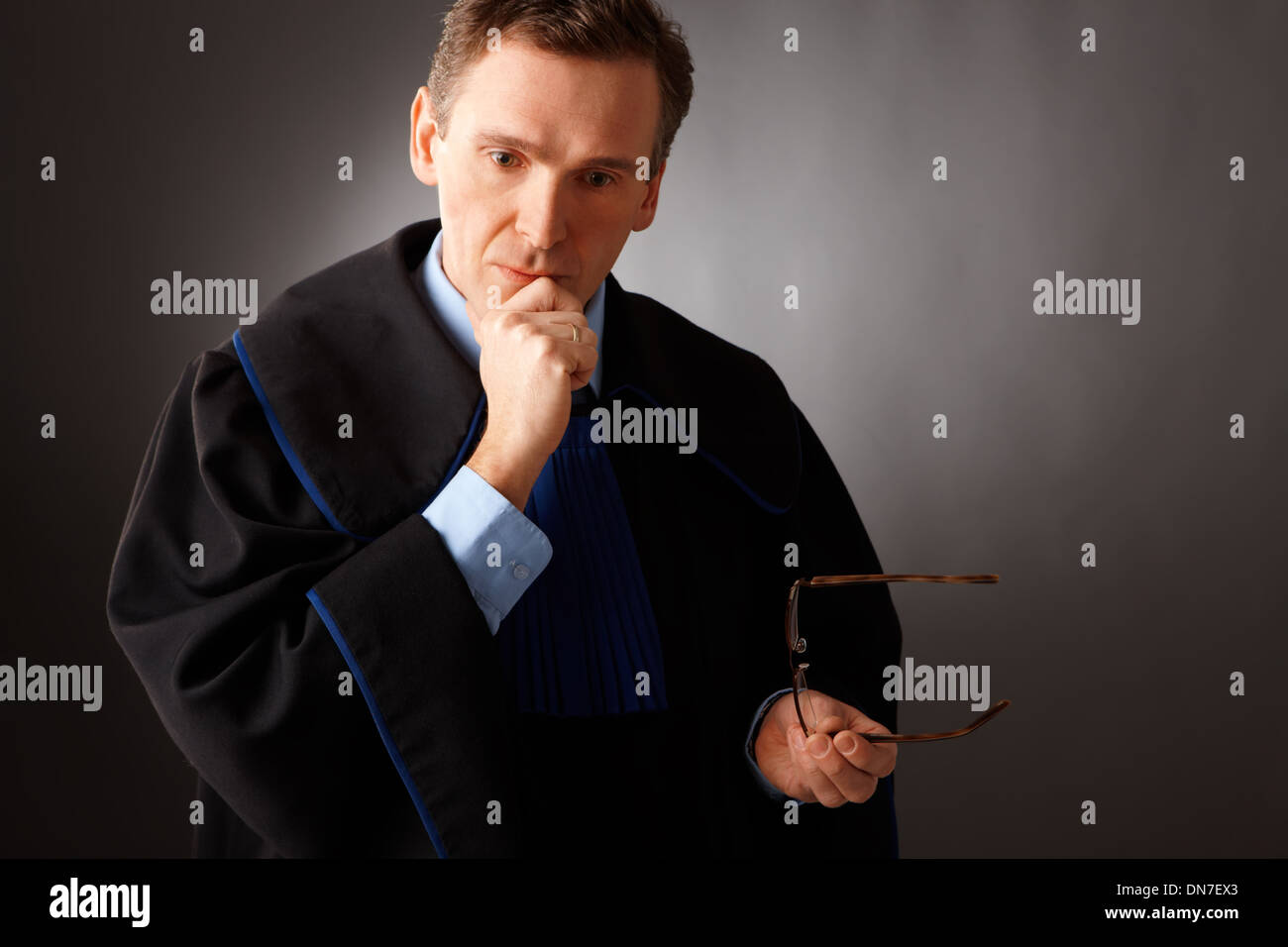 Attorney wearing classic gown thinking in court Stock Photo - Alamy