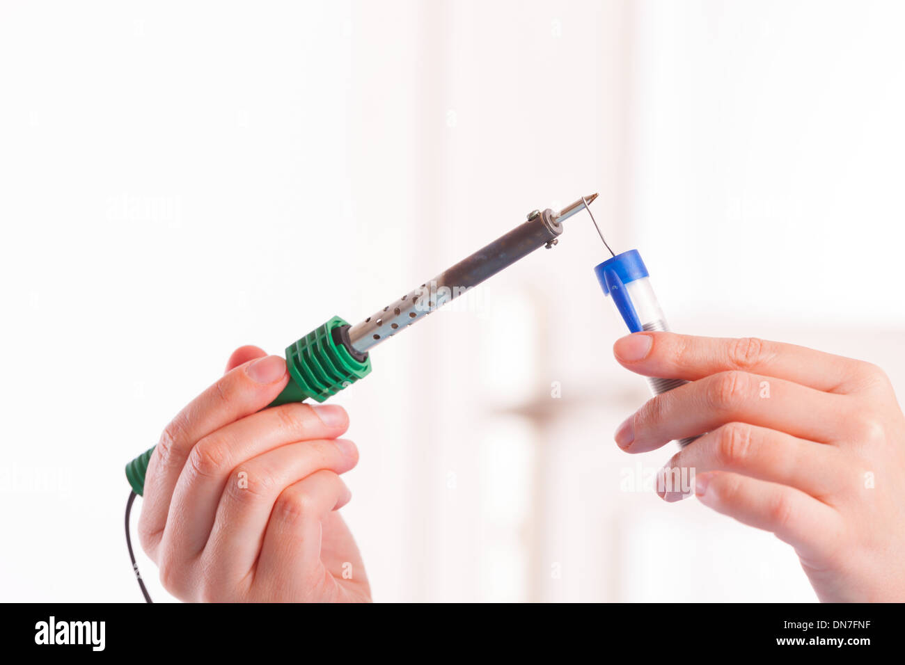 Hands with soldering tool and solder wire Stock Photo - Alamy