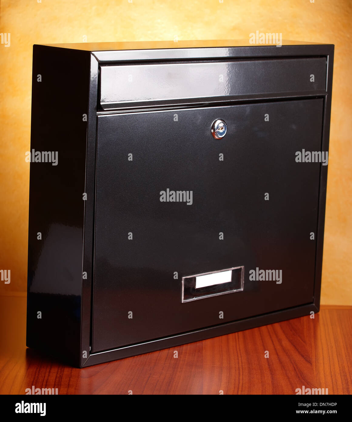 Metal milbox on wooden desk Stock Photo - Alamy