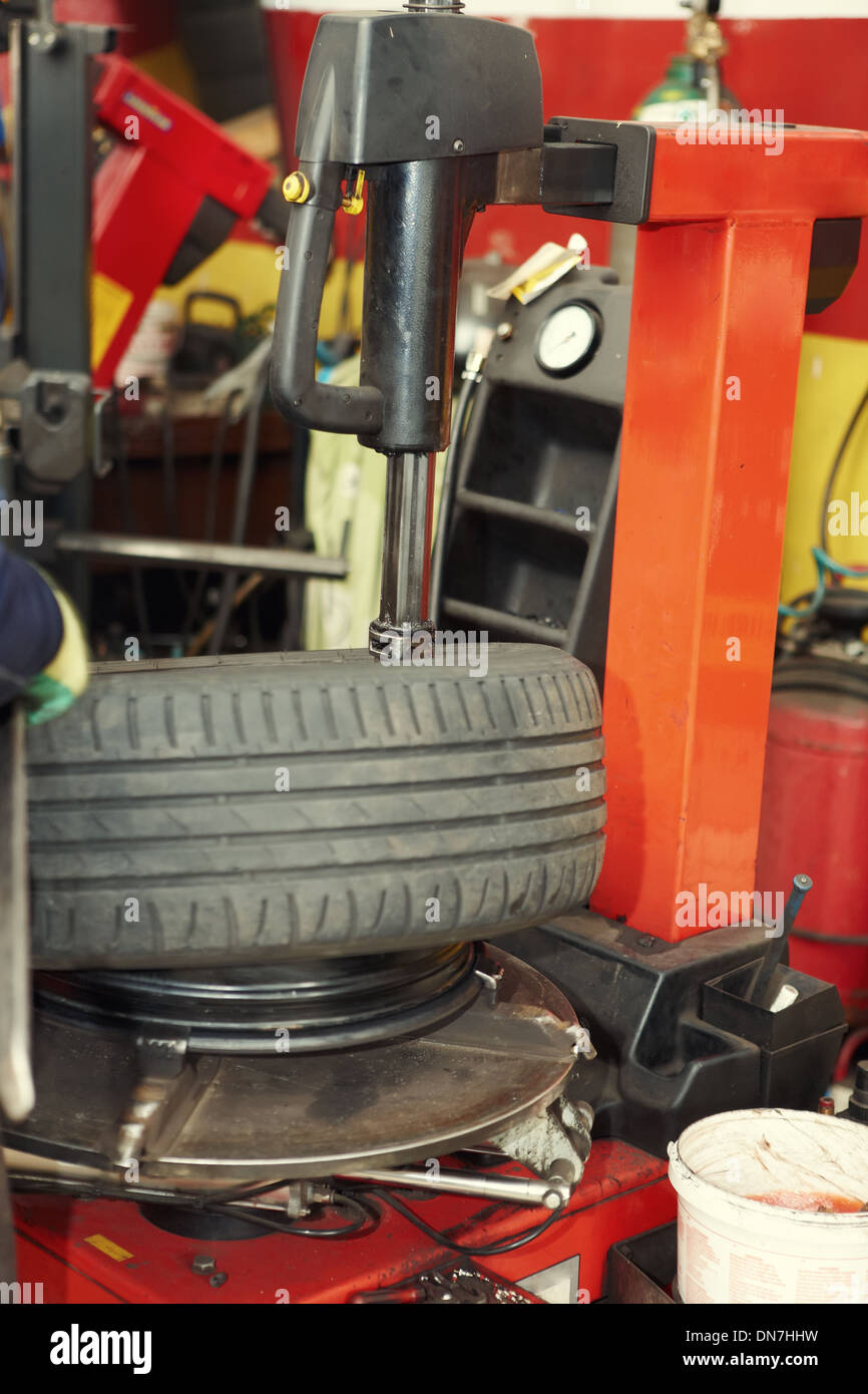 Professional auto mechanic changing a tire in auto repair shop Stock ...