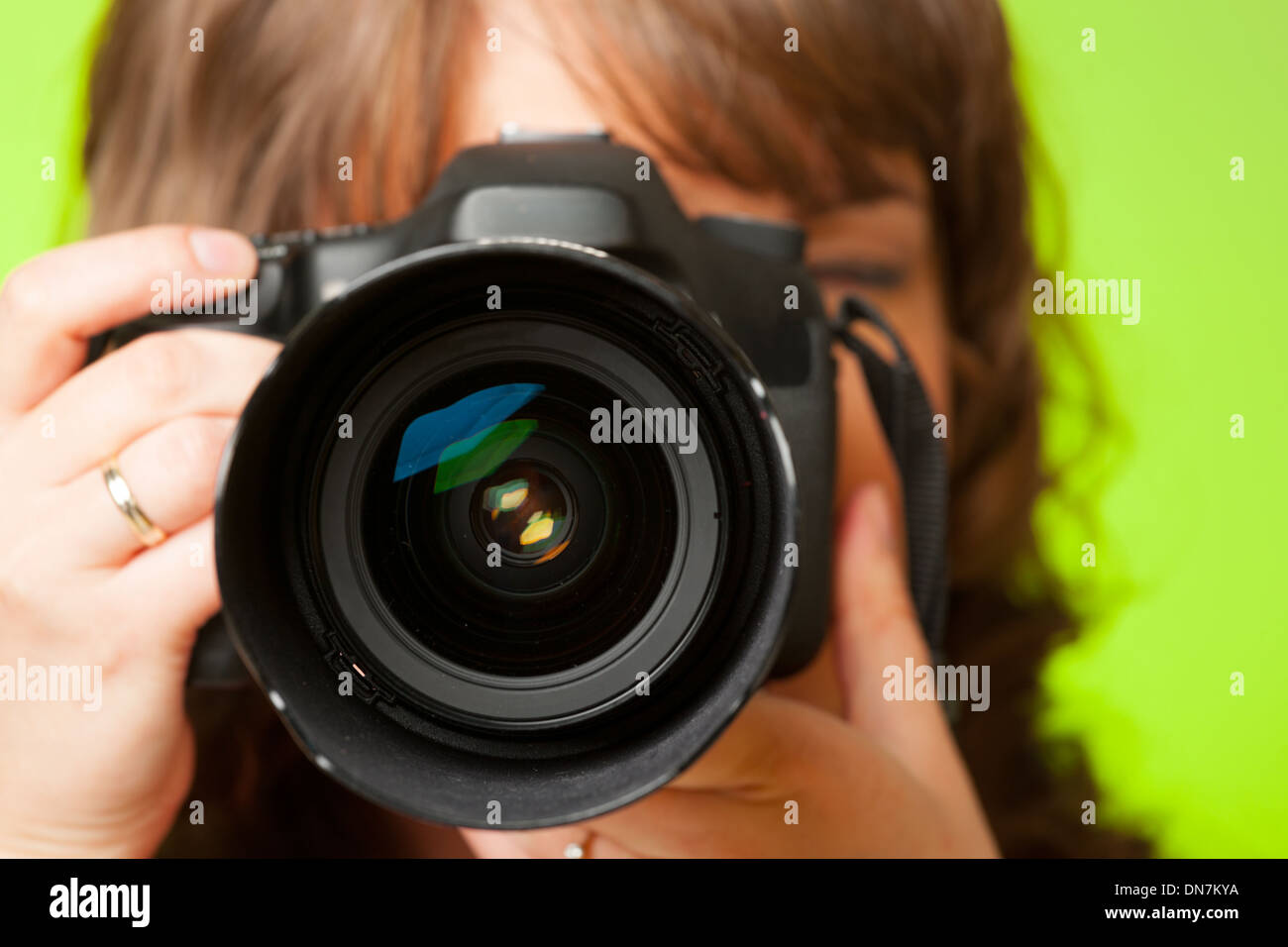 Female photographer taking photos with DSLR digital camera Stock Photo ...