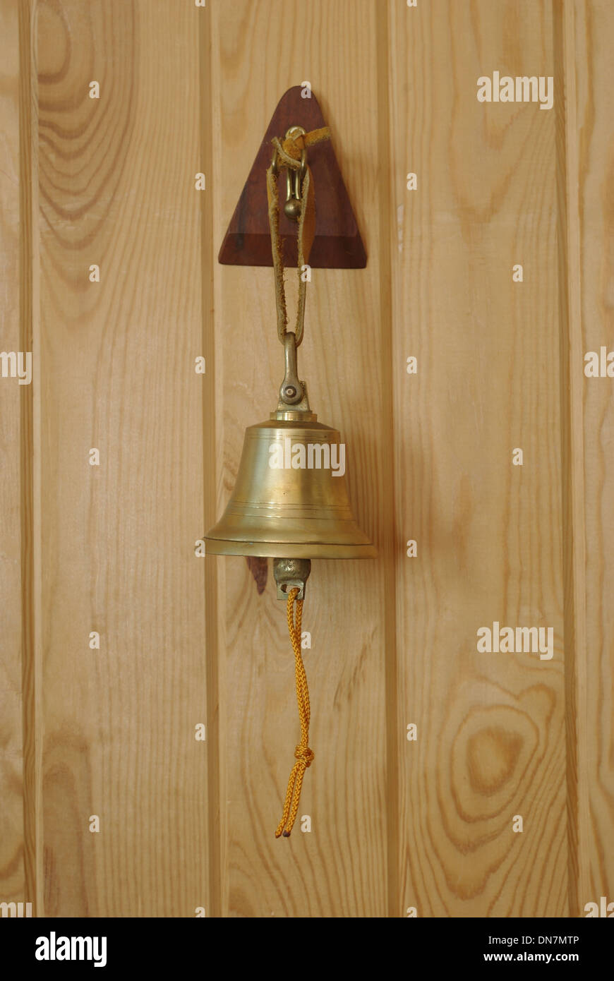 brass bell on a wooden boards background Stock Photo - Alamy