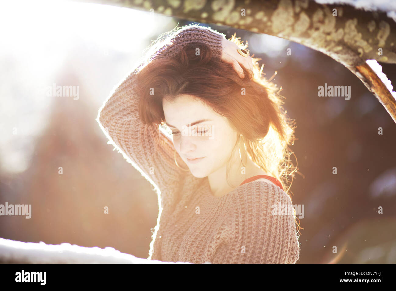 Portrait of a young woman in the snow in backlight Stock Photo - Alamy
