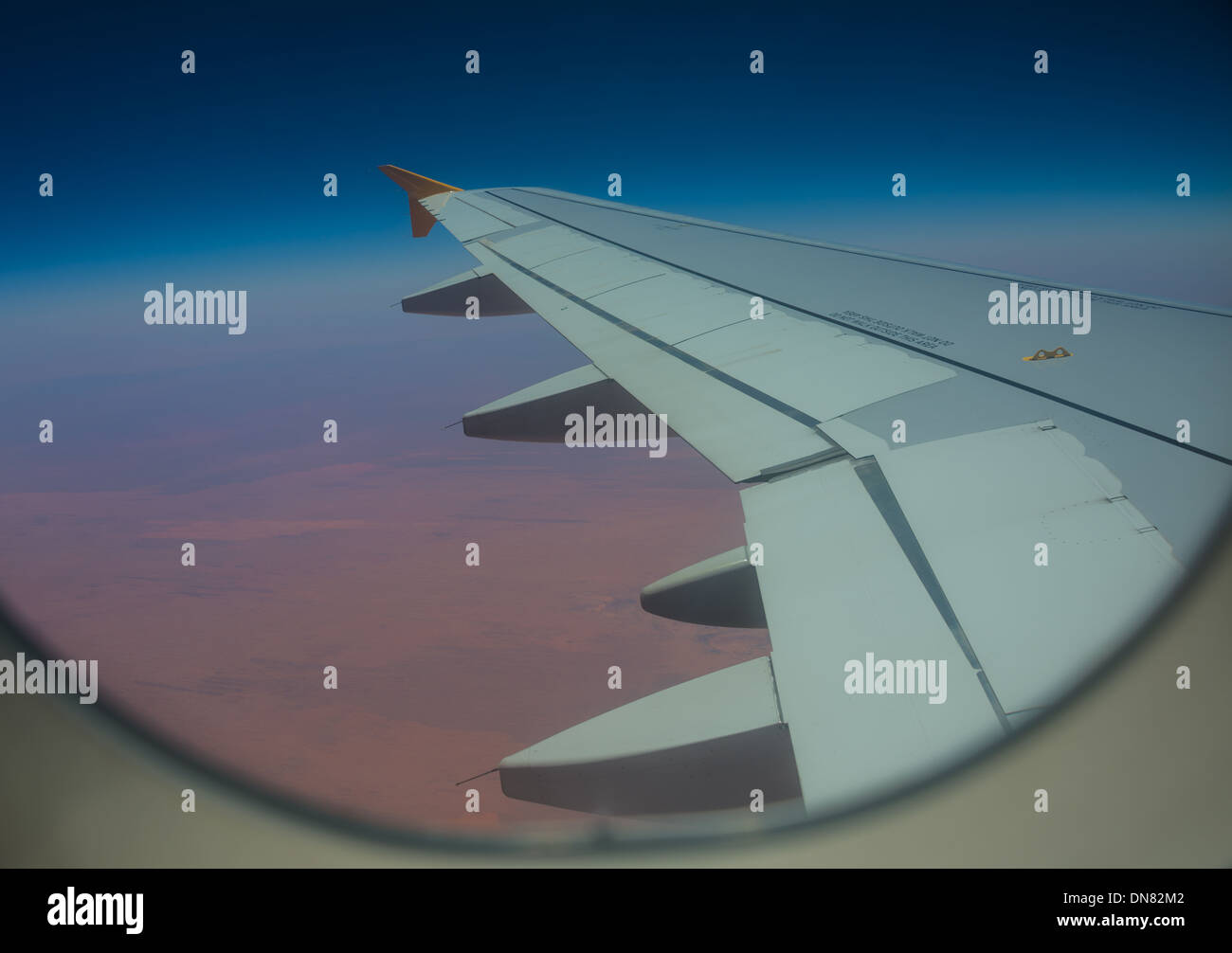 from the window of plane above the desert flying in sky aerial shots of ...