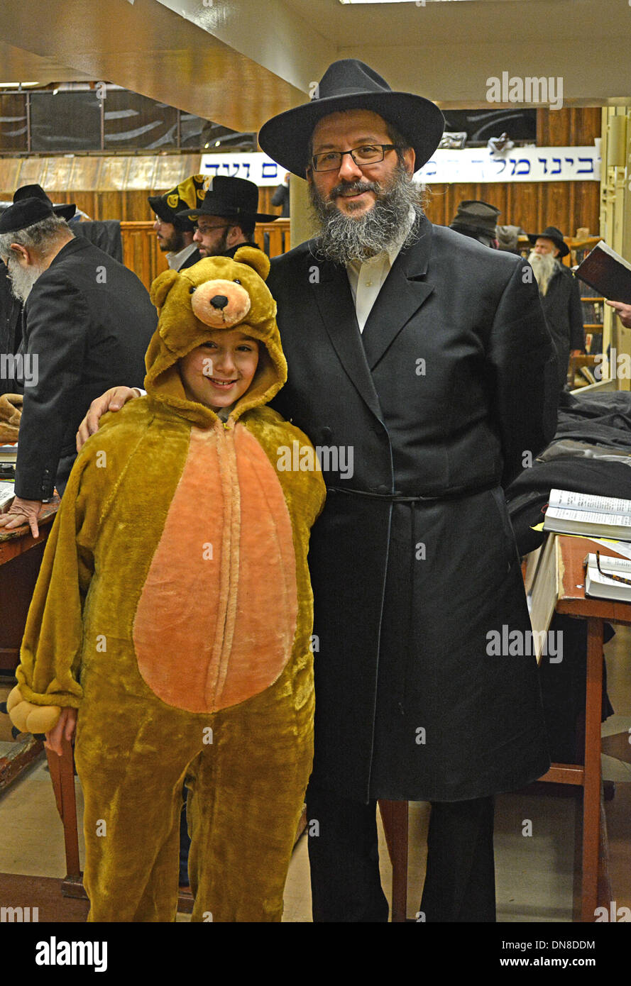 Religious Jewish father with his son who is in costume for the Purim ...