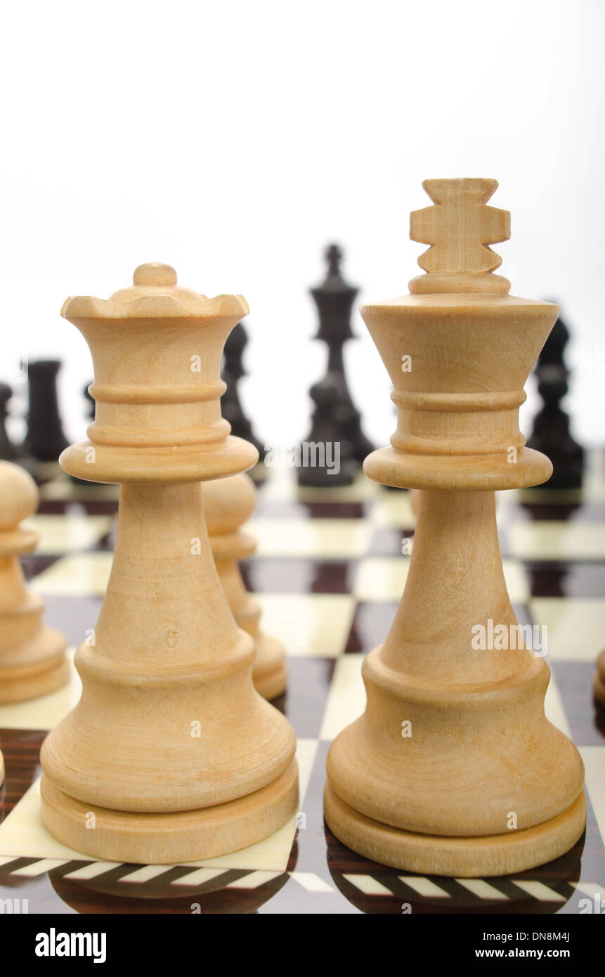 traditional wooden chess pieces on chessboard in different positions ...