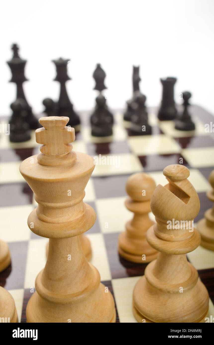 traditional wooden chess pieces on chessboard in different positions ...