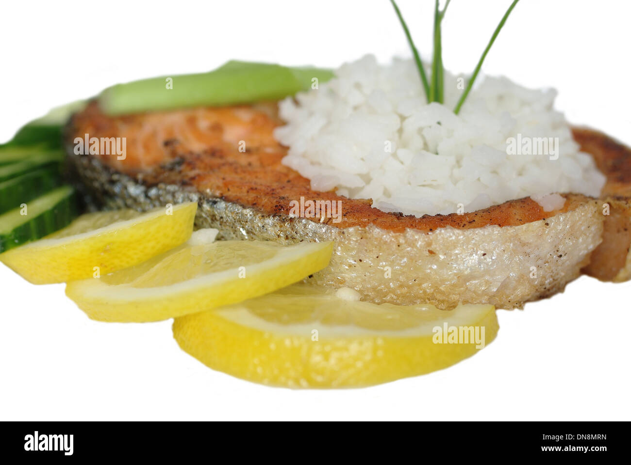 fried salmon with vegetables on white background Stock Photo - Alamy