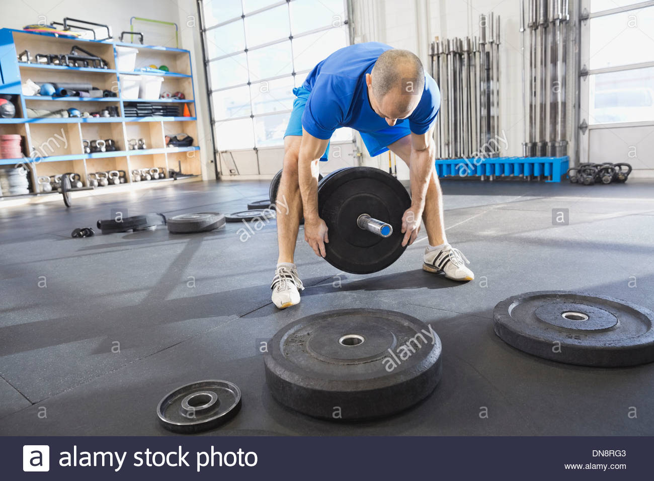 Adding weights hi-res stock photography and images - Alamy