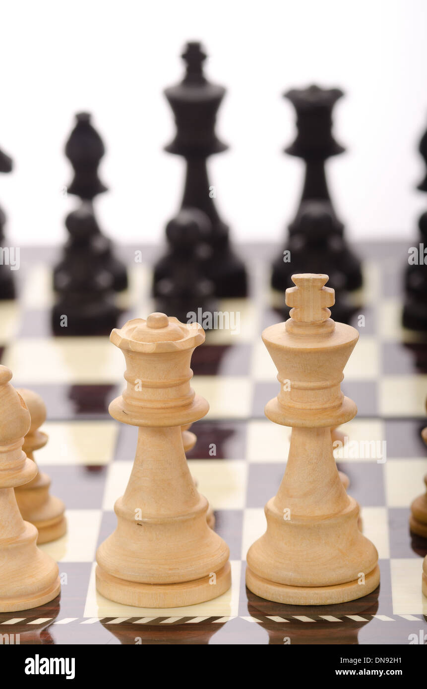 traditional wooden chess pieces on chessboard in different positions ...