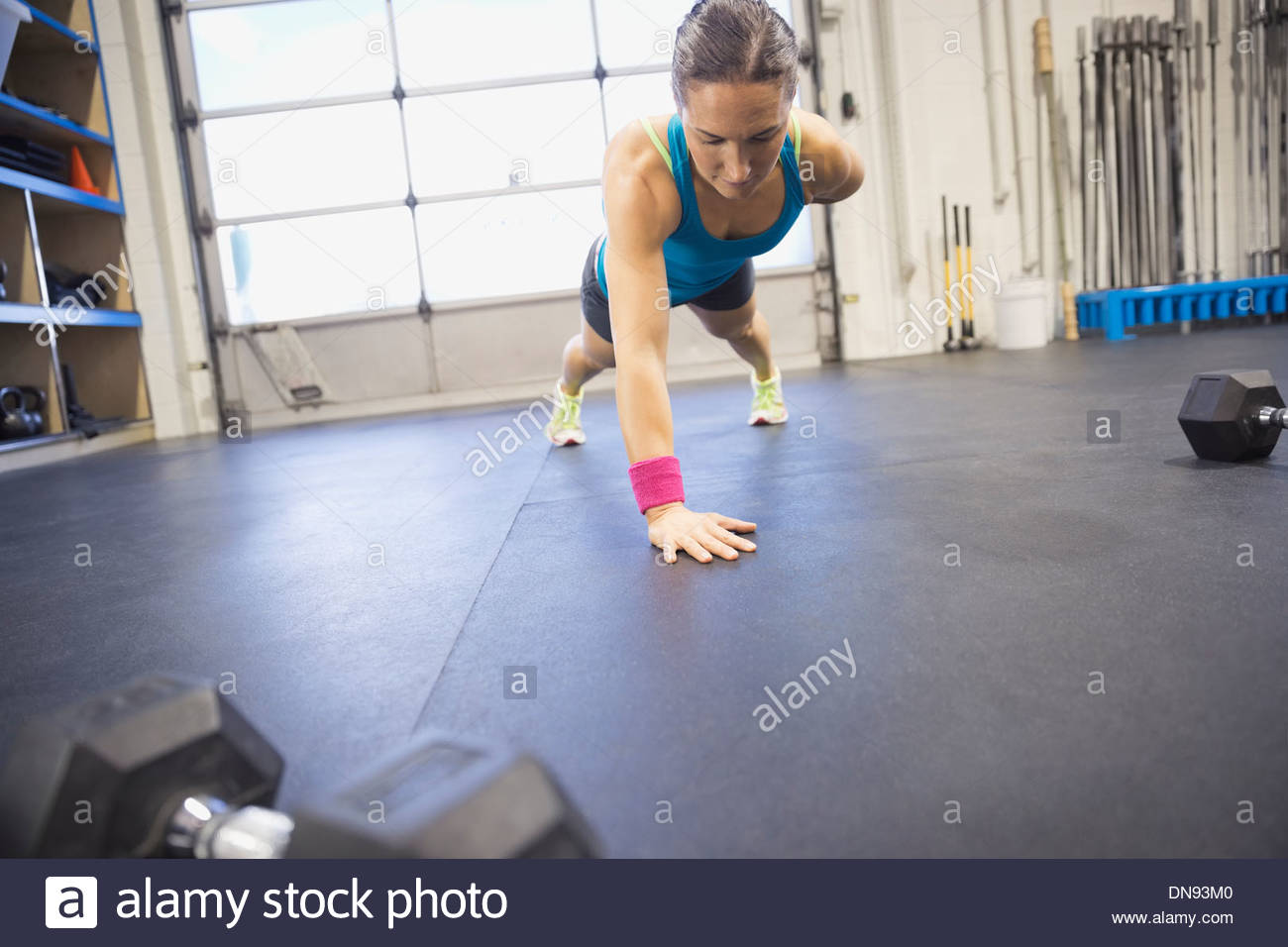 Determined woman doing one arm push-ups in gym Stock Photo - Alamy