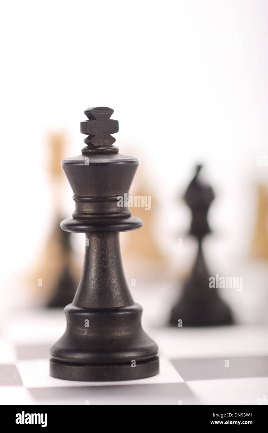 traditional wooden chess pieces on chessboard in different positions ...