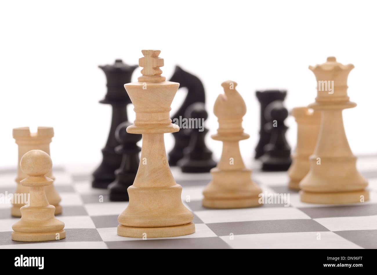 traditional wooden chess pieces on chessboard in different positions ...