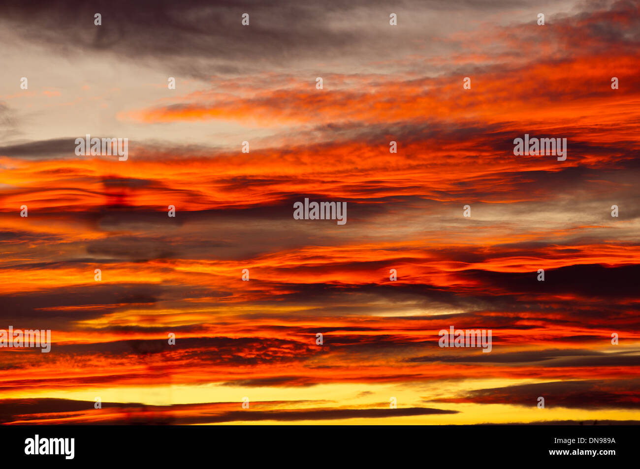 Red sunset with colorful layers clouds Stock Photo - Alamy