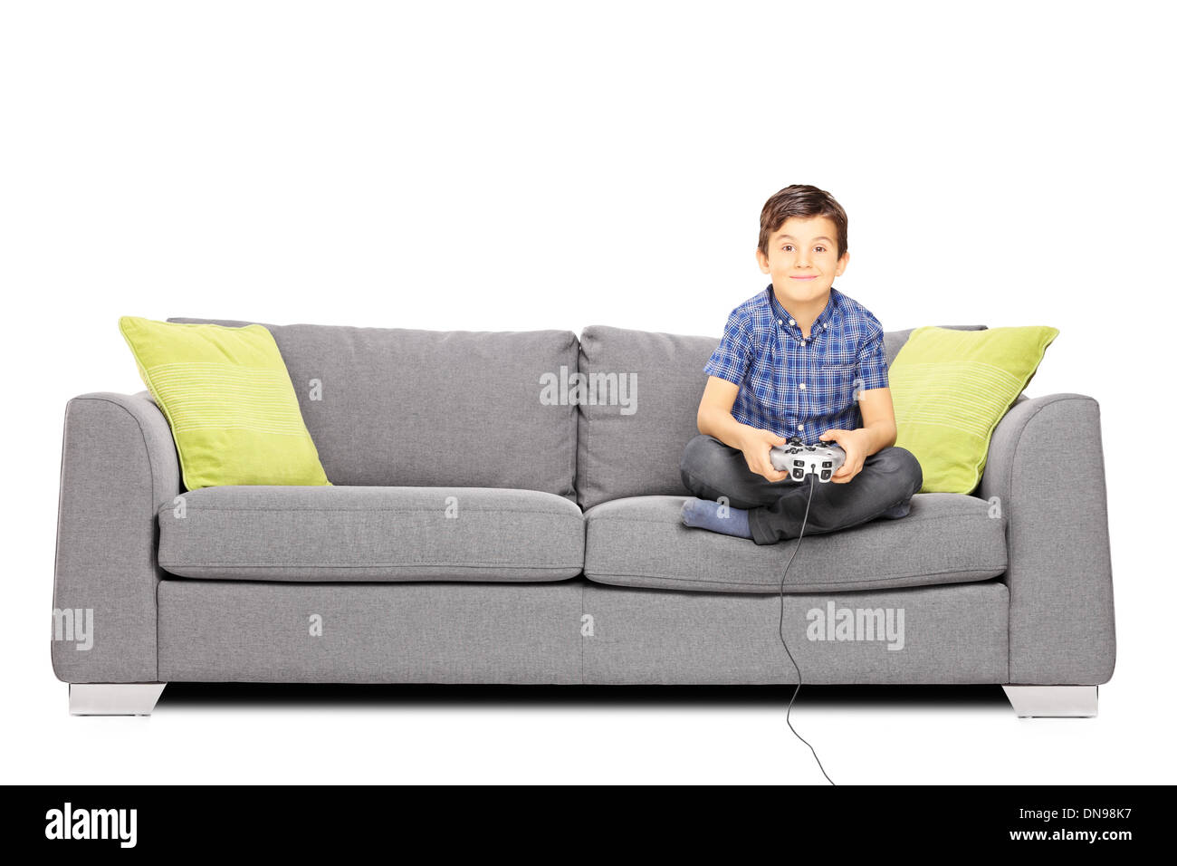 Boy smiling sitting on a sofa Cut Out Stock Images & Pictures - Alamy