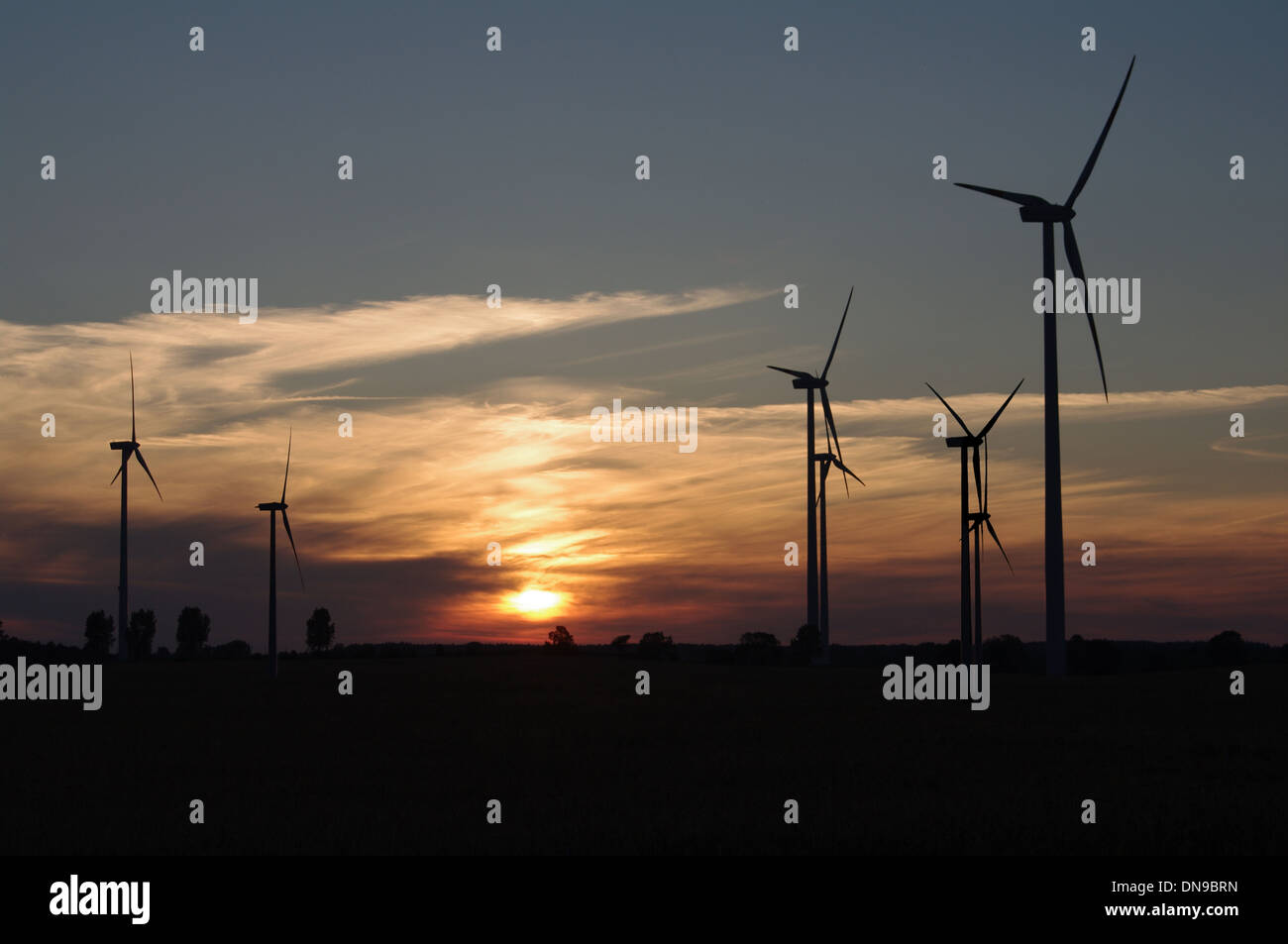 wind turbine on sunset background Stock Photo - Alamy