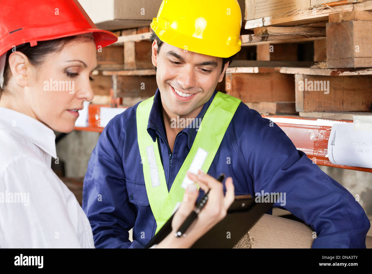 Supervisor Showing Clipboard To Foreman Stock Photo - Alamy