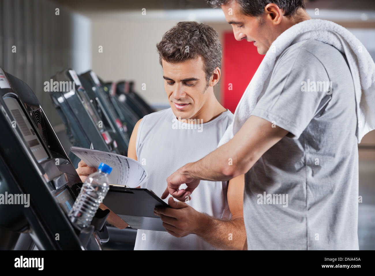 Instructor Guiding Man To Fill The Membership Form Stock Photo - Alamy