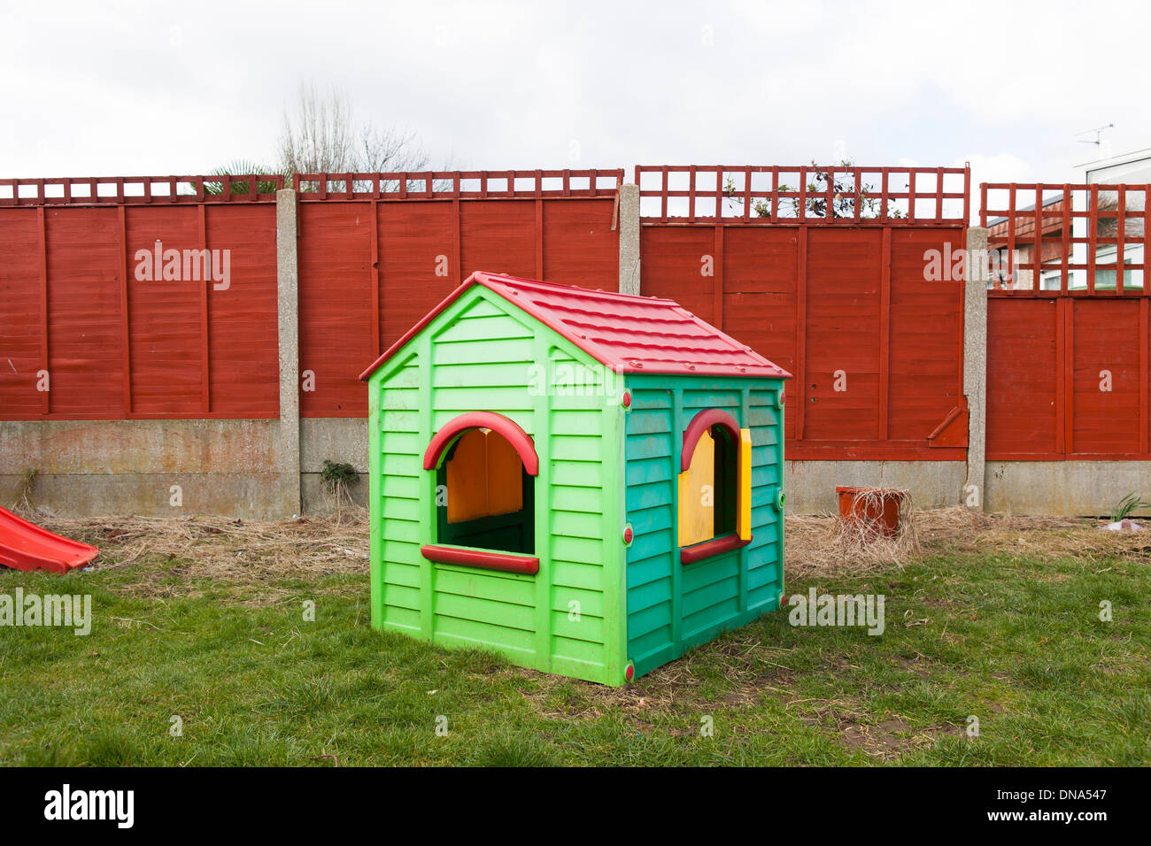 green plastic playhouse in a scruffy back garden in england Stock Photo ...