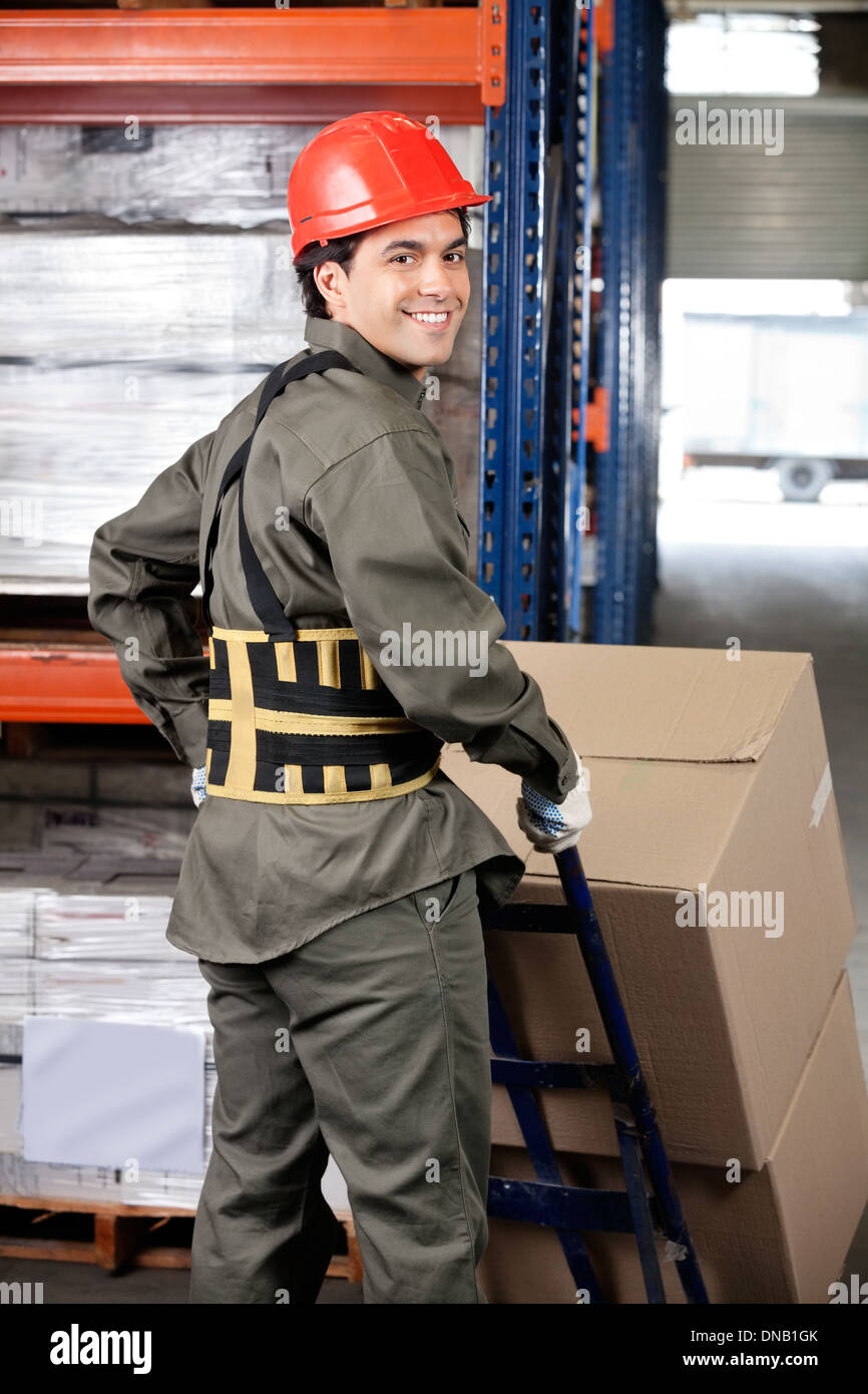 Warehouse Worker Pushing Handtruck Stock Photo - Alamy