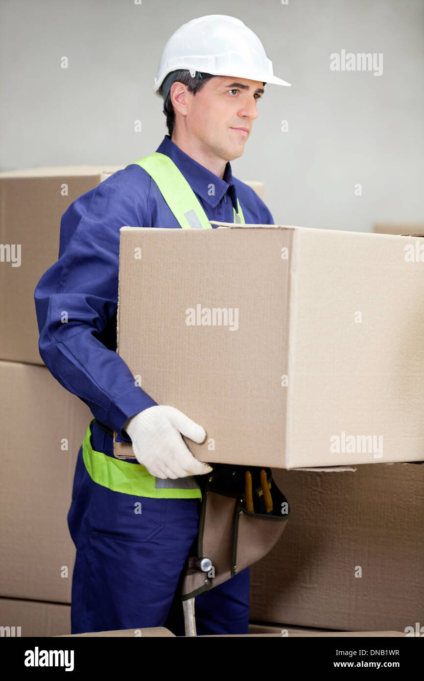 Foreman Lifting Cardboard Box At Warehouse Stock Photo - Alamy