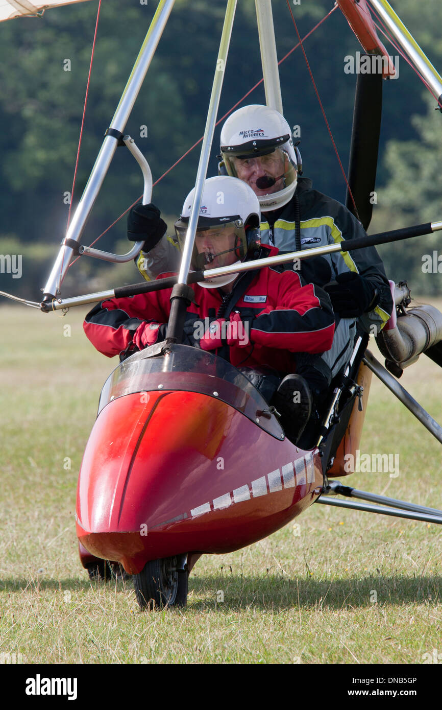 Pilot and passenger readying themselves for take-off in a microlight ...