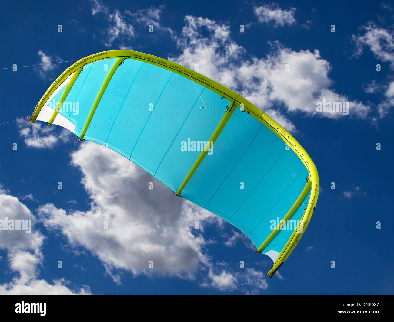 blue sky with white clouds and blue and green kite for kitesurfing ...