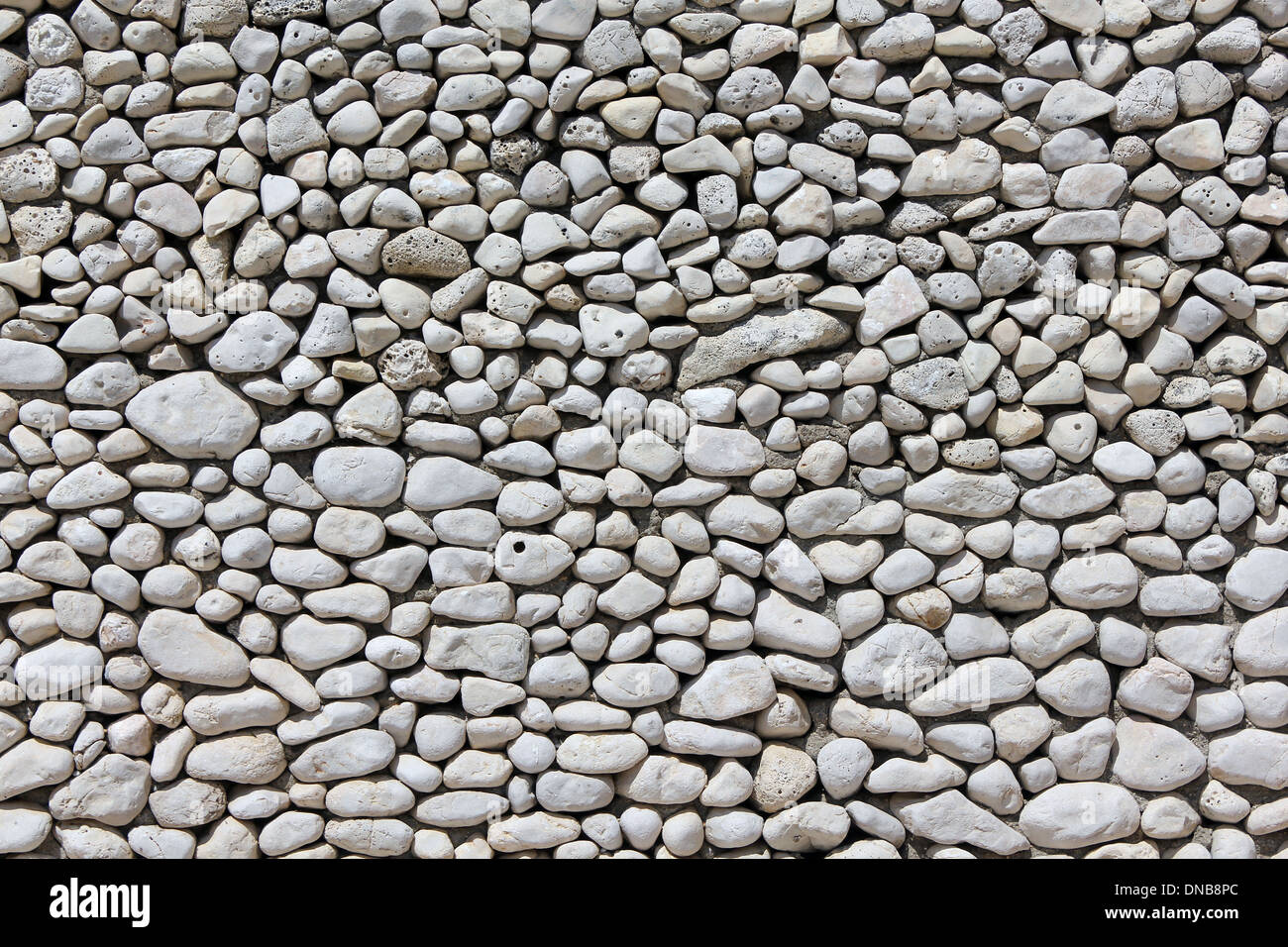 wall made of small white sea pebbles Stock Photo - Alamy
