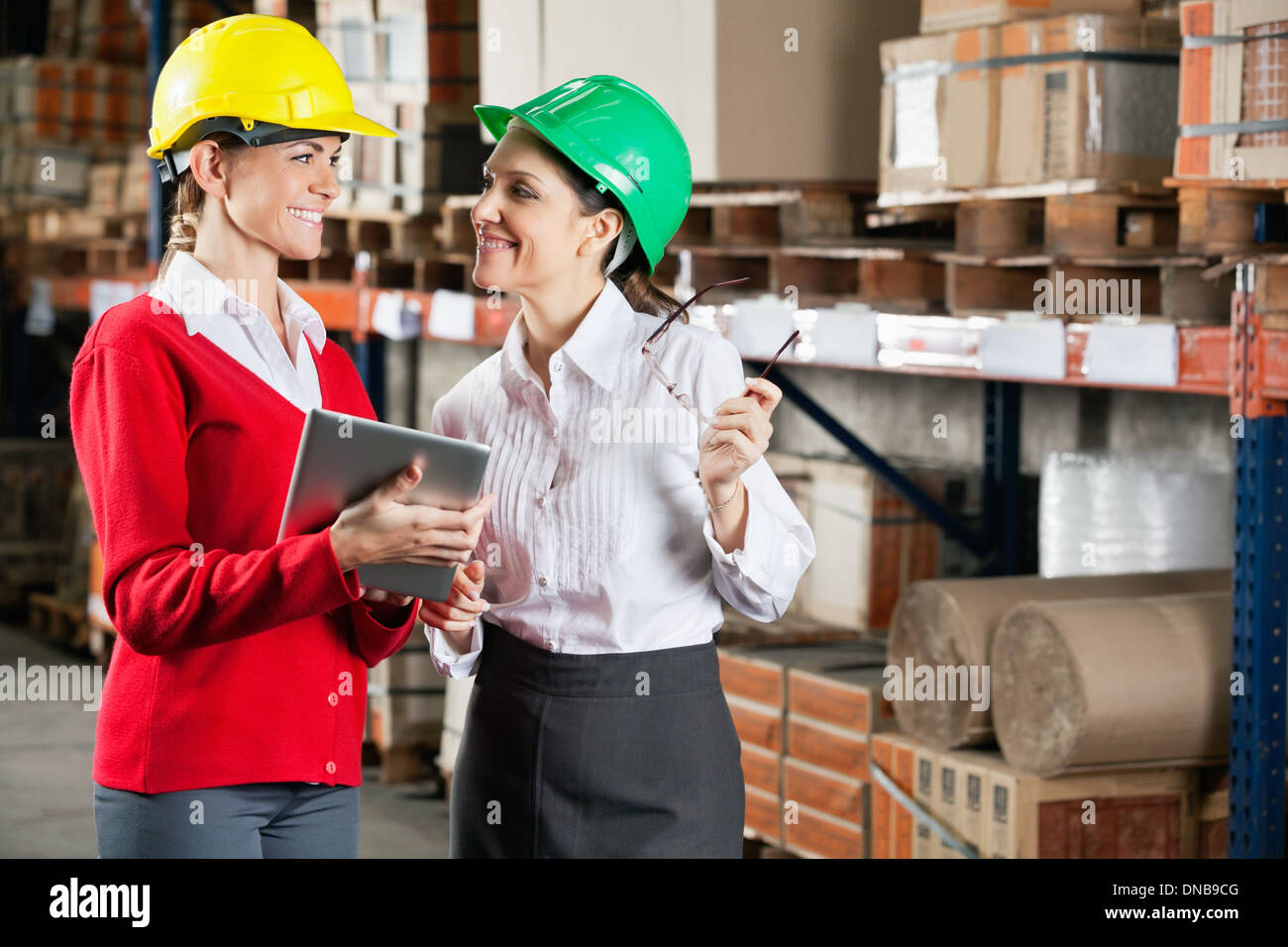 Female Supervisors Discussing Work At Warehouse Stock Photo - Alamy