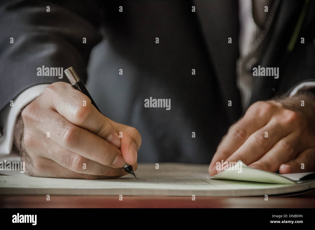 Wedding day. Groom signing the register Stock Photo - Alamy