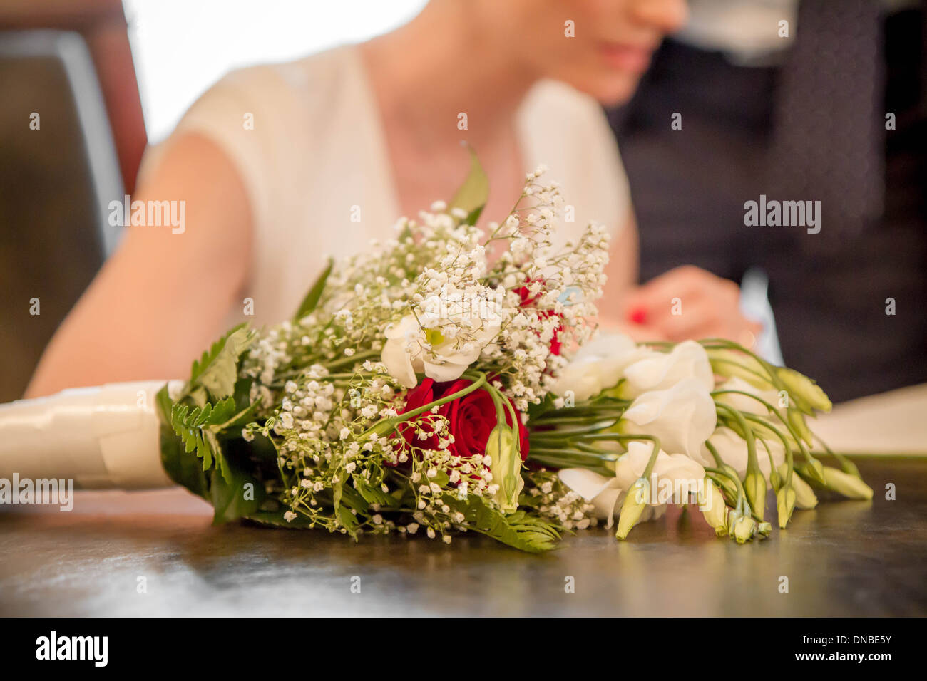 Wedding day bride signs the register Stock Photo - Alamy