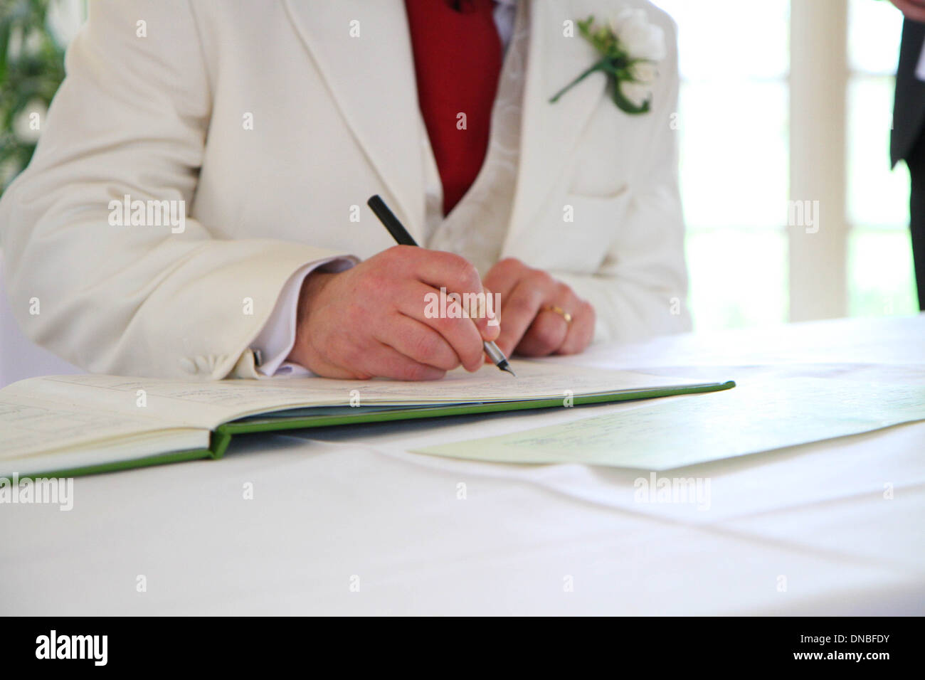 Wedding day signing the register Stock Photo - Alamy