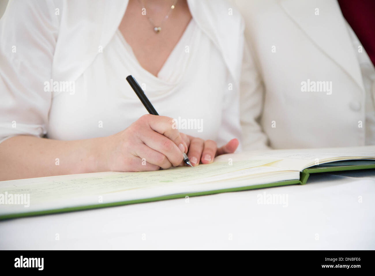 Wedding day signing the register Stock Photo - Alamy