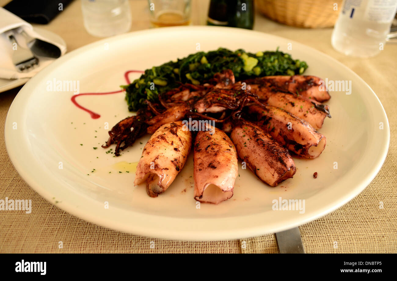 Diner scene typical dalmatian food charcoal fried squid Istria Adriatic ...
