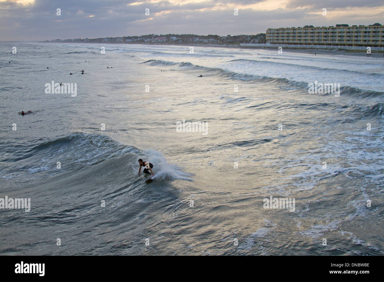 Folly Beach, South Carolina, USA - October, 25, 2012: Surfer riding the ...