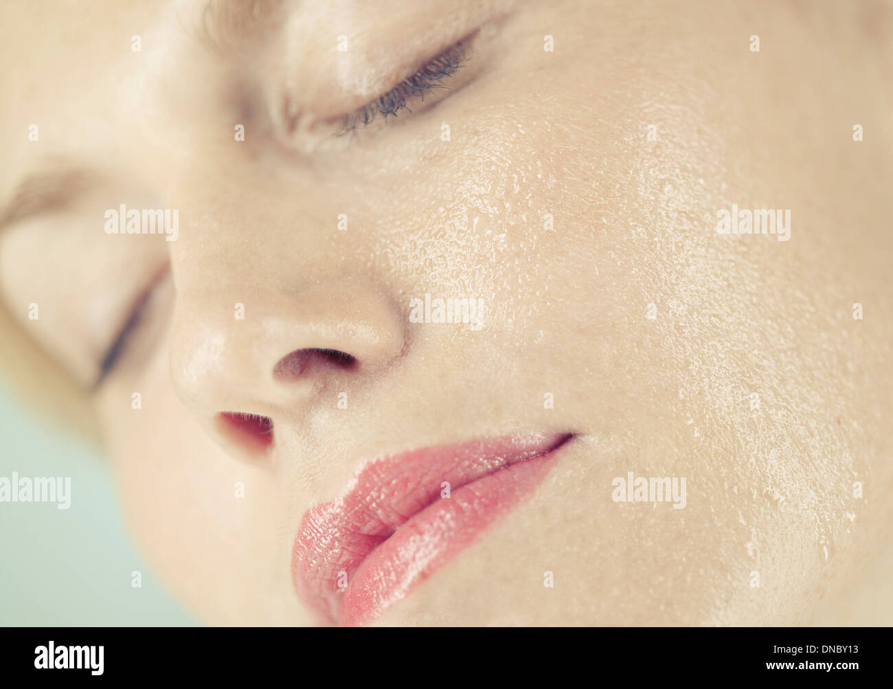A young woman with eyes closed, sweating Stock Photo - Alamy