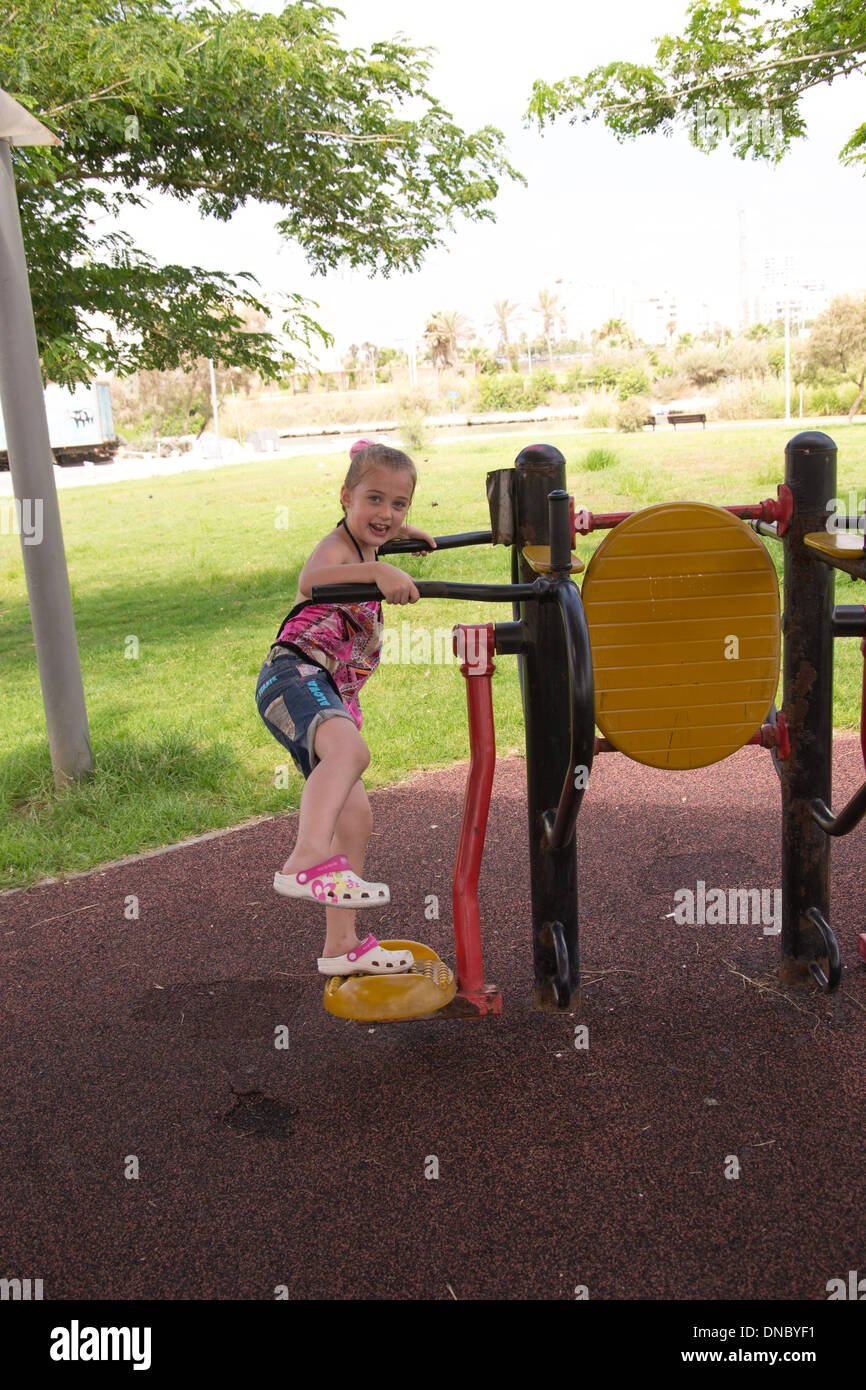 Little girl on street exercise machines Stock Photo - Alamy