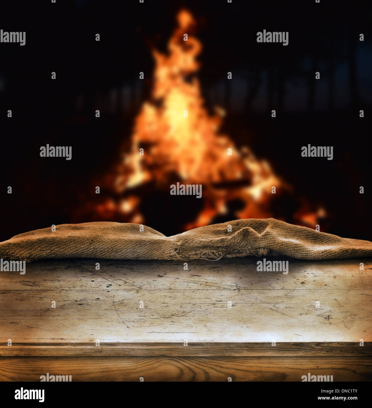 Empty wooden table and campfire in background. Great for product ...