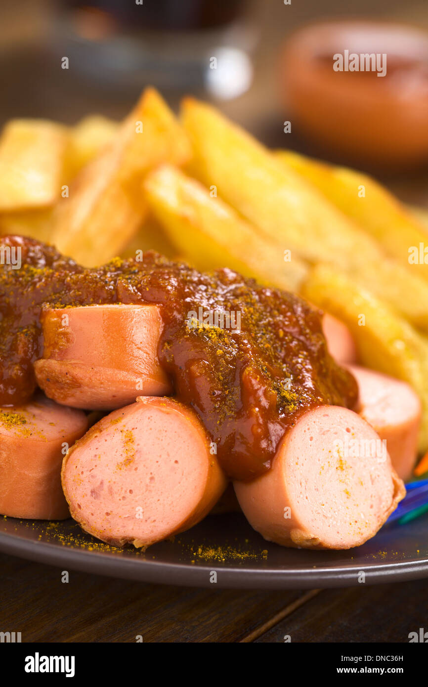 German fast food called Currywurst served with French fries on a plate ...