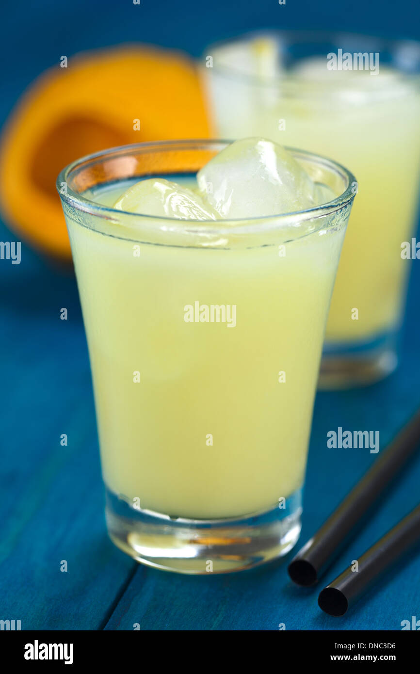 Peruvian cream liqueur made of lucuma fruit served in glass with ice ...