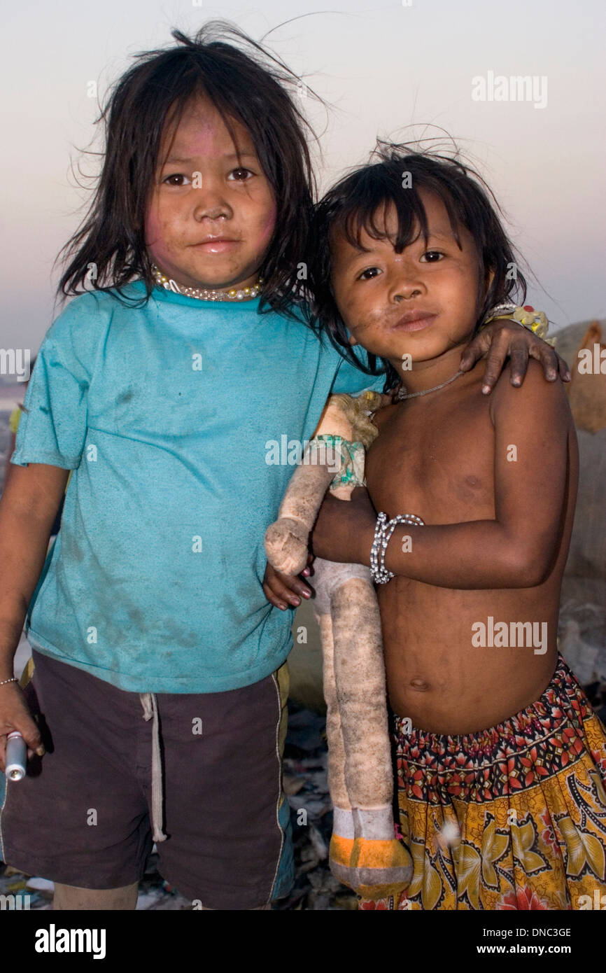 Two young child laborer girls are resting at the toxic Stung Meanchey ...